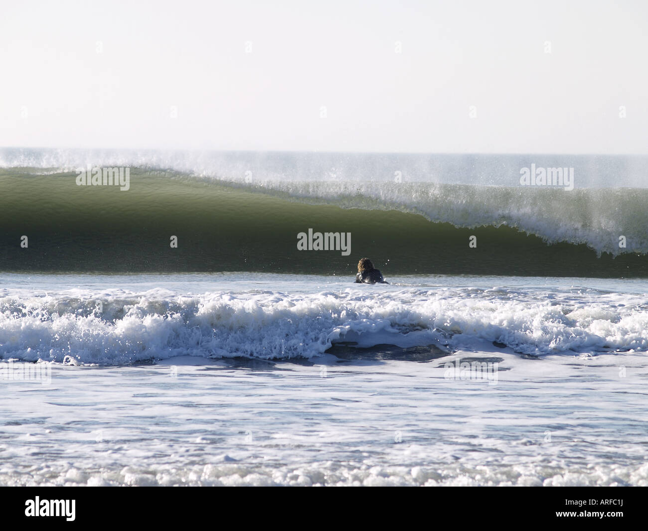 Bodyboarder paddling out towards the waves Stock Photo - Alamy