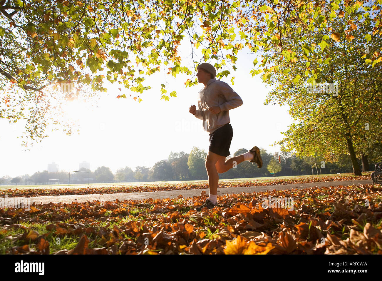 Young man running in park Stock Photo - Alamy