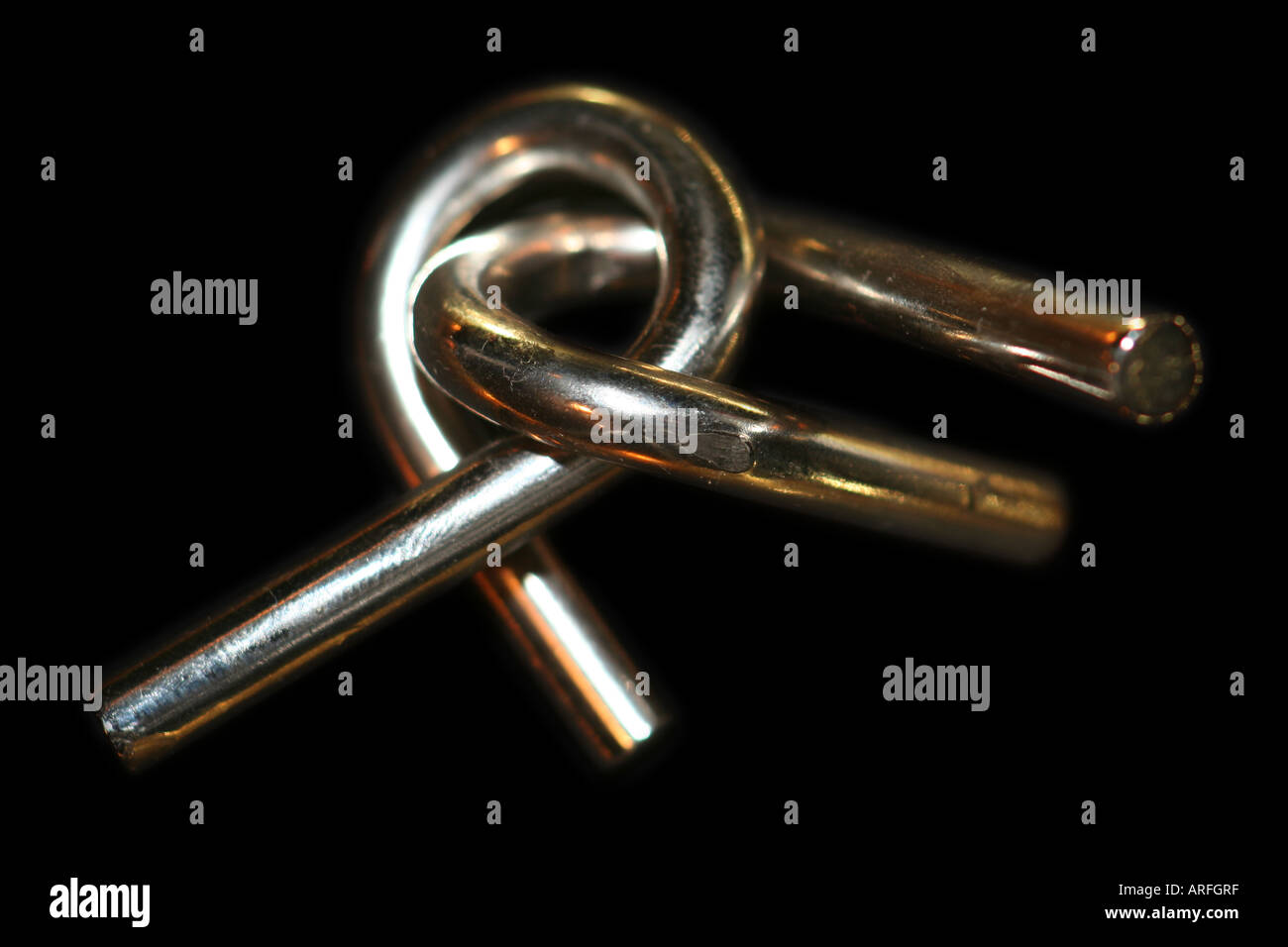 Steel puzzle over a black background Stock Photo - Alamy
