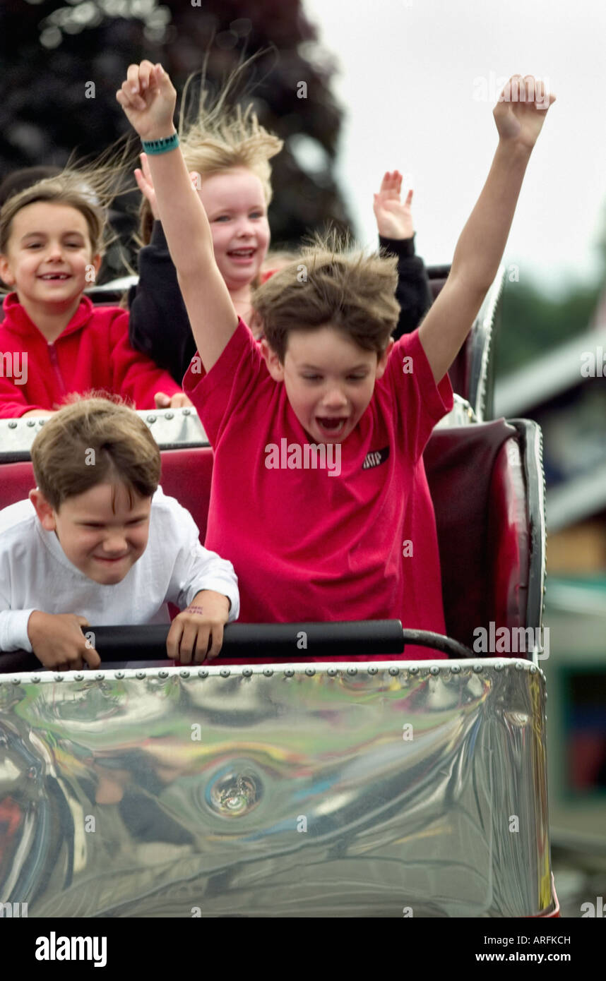 Young Children on Mini Roller Coaster Stock Photo - Alamy