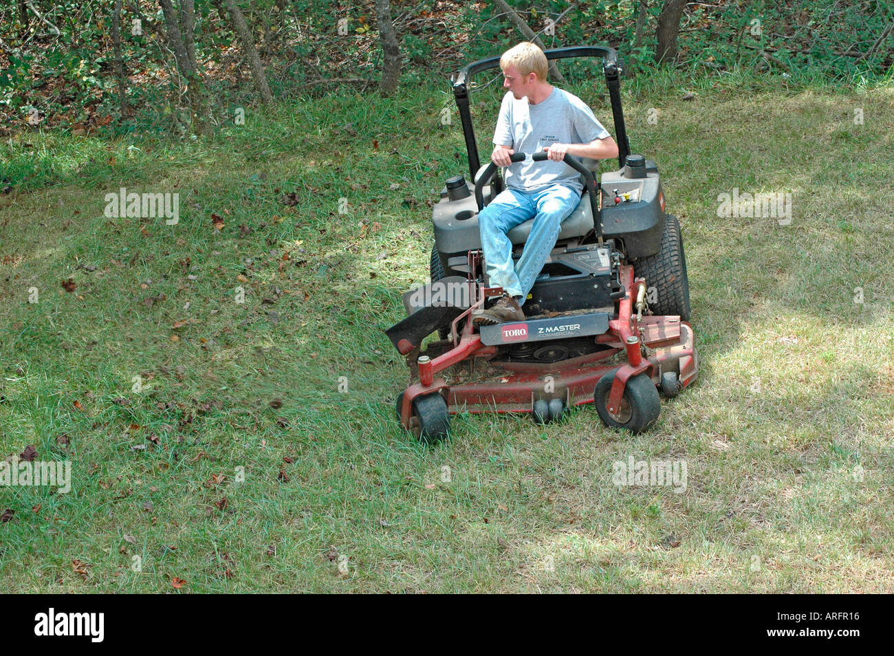 Man Cutting Yard grass Lawn on Ridding Mower Southern USA America for a ...