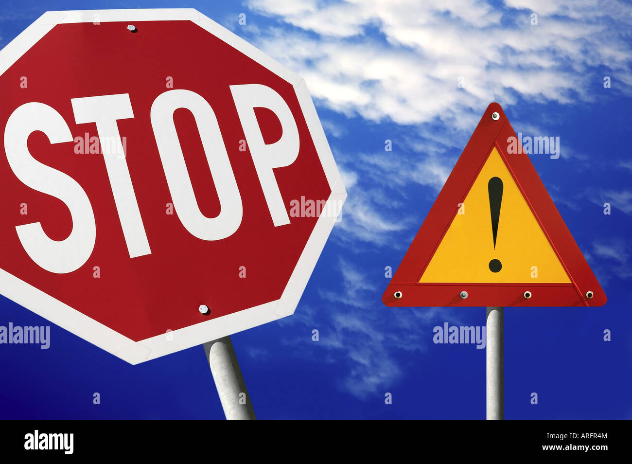 Stop sign and warning sign on blue sky background Stock Photo - Alamy