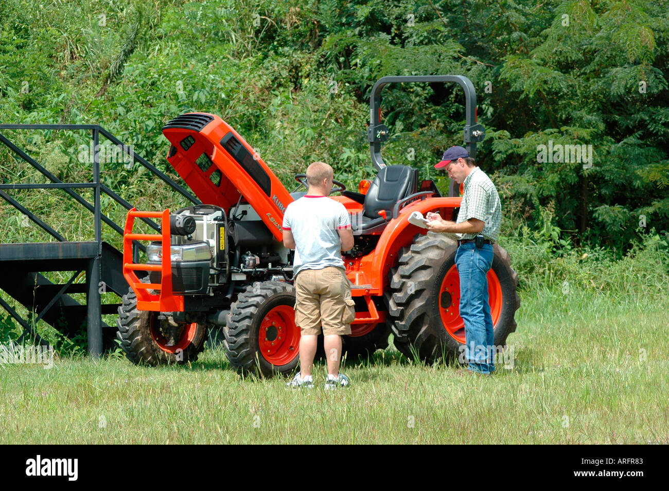 High School students learning how to drive a new real tractor with ...
