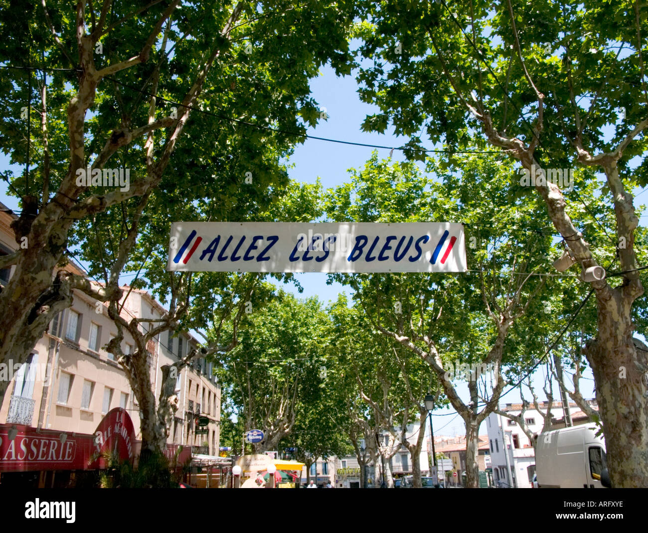 a banner bearing the slogan 'allez les bleus' hangs over an avenue from ...