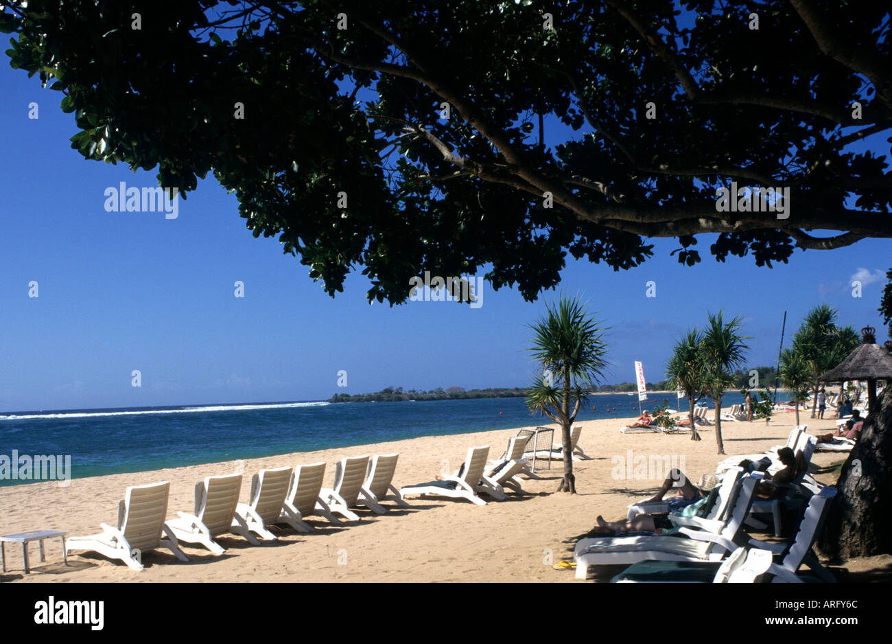 Bali Blue water beach shore coast shoreline people Stock Photo - Alamy
