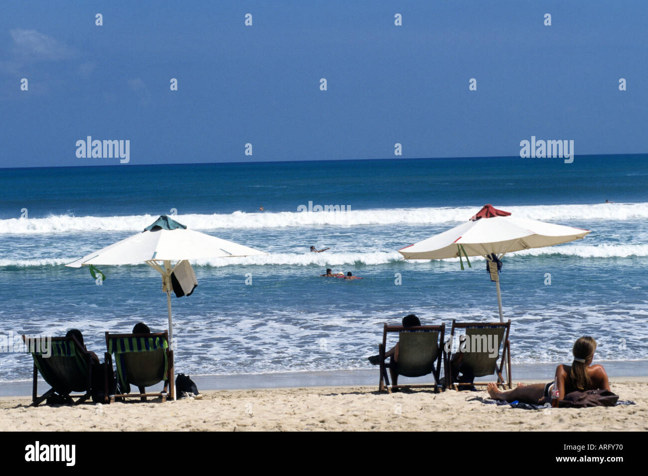 Bali Blue water beach shore coast shoreline people Stock Photo - Alamy