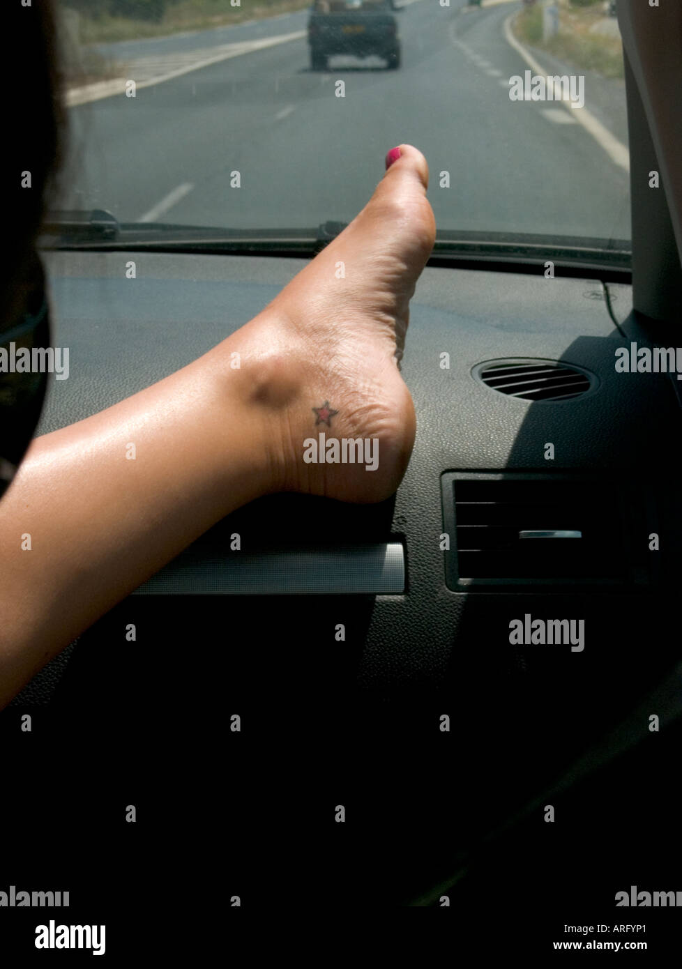 A cropped view of a pair of female feet on a car dashboard Stock Photo ...