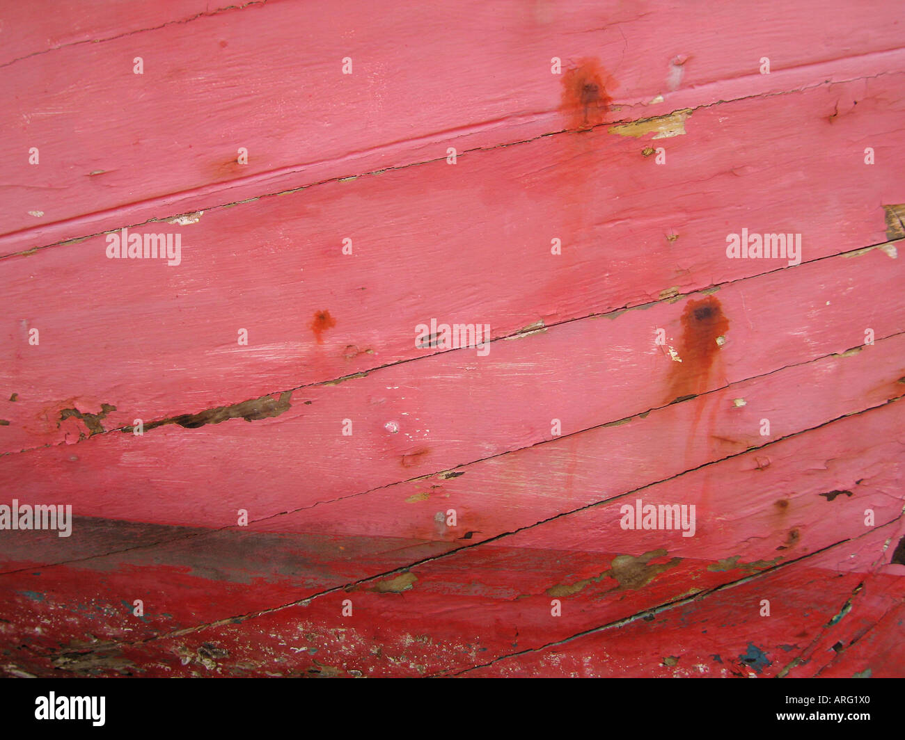 Faded red paint on hull of boat Stock Photo - Alamy