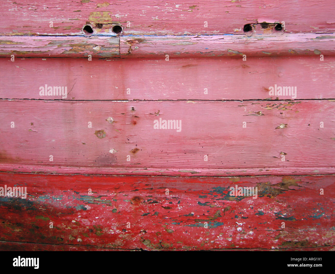 Faded red paint on bow of boat Stock Photo - Alamy