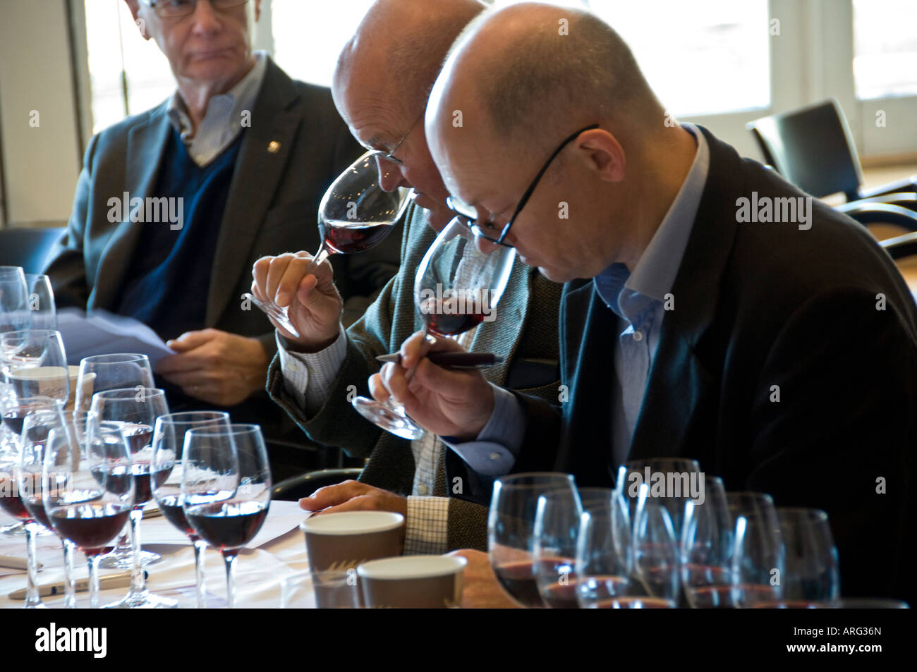 Group of people tasting red wine Stock Photo - Alamy