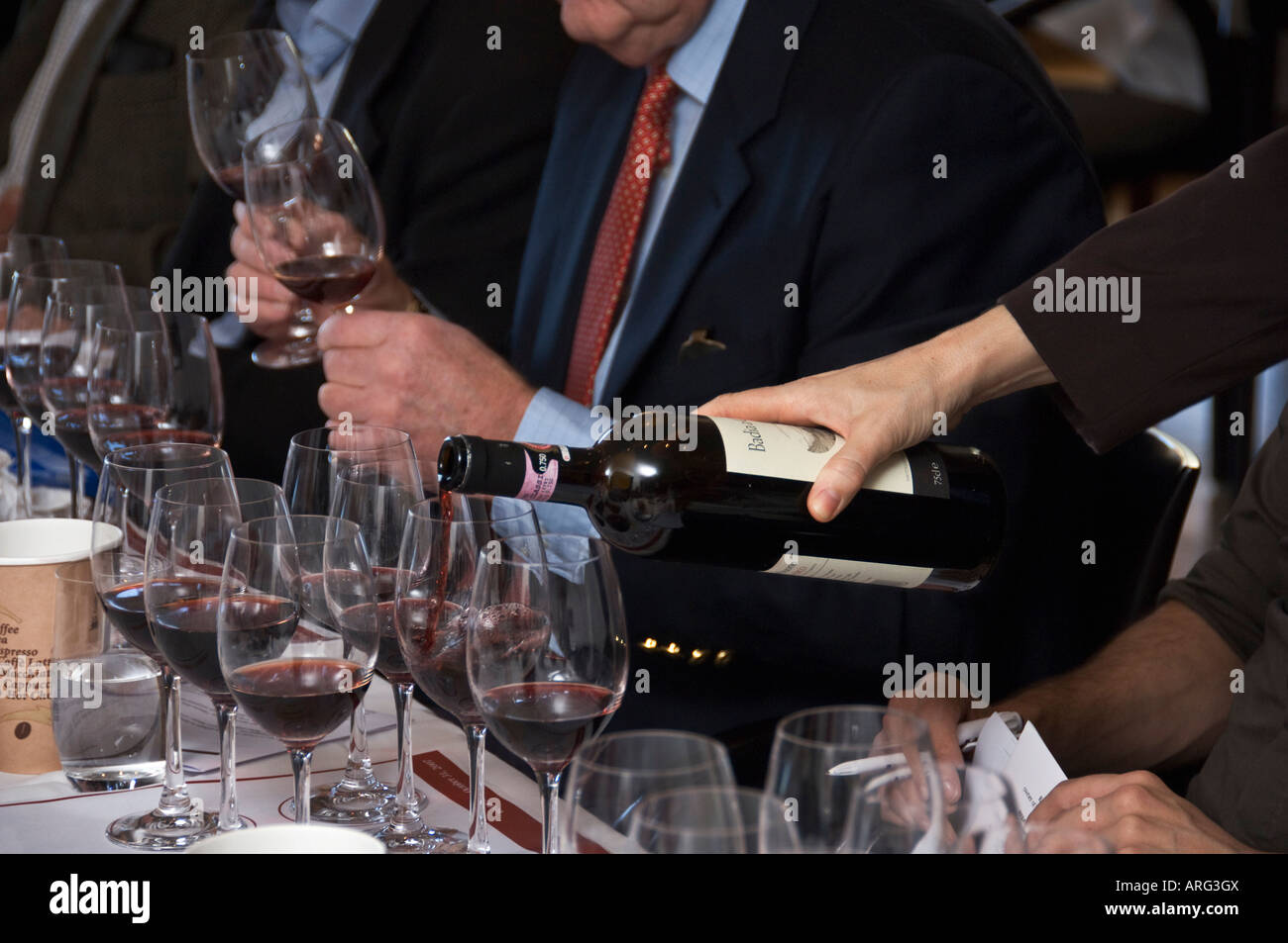 Group of people tasting red wine Stock Photo - Alamy