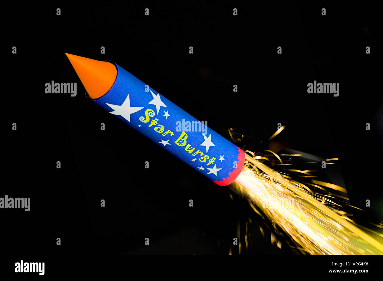 A firework rocket with trail of sparks captured against black Stock ...