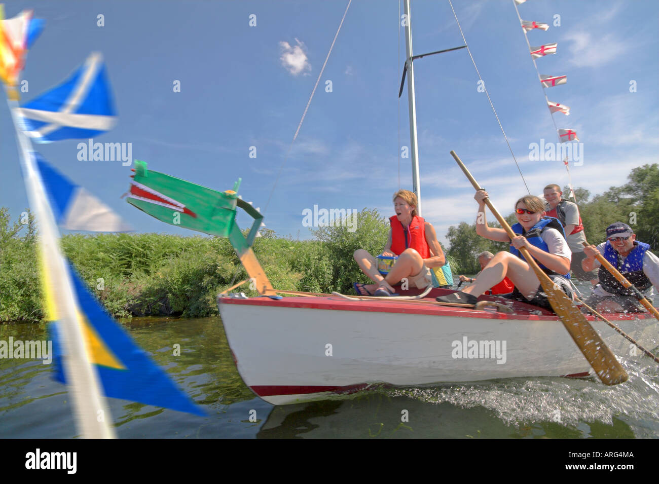 A group of people enjoy racing their home made dragon boat at a boating ...