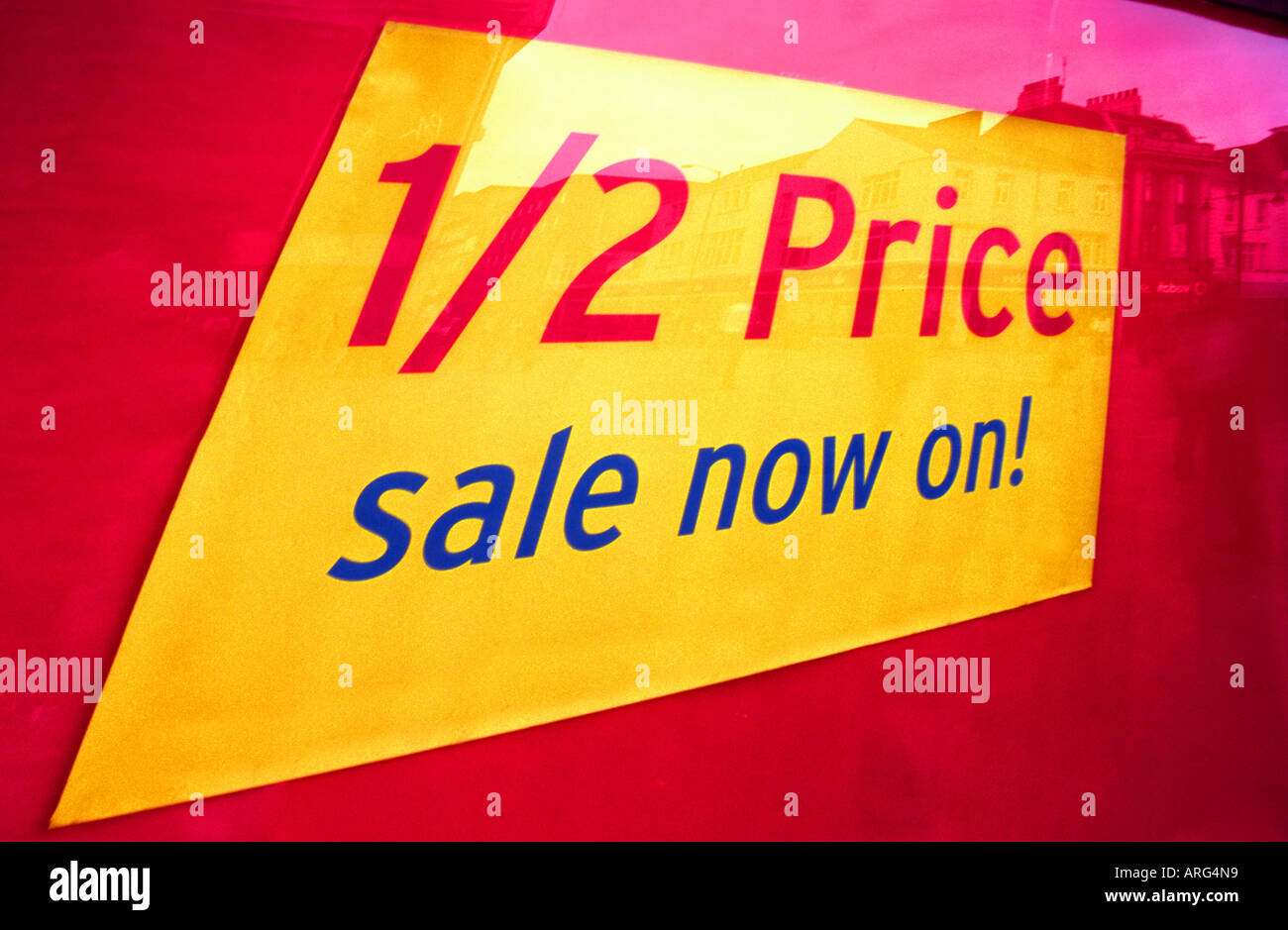 Overt shop window poster advertising ½ price sale is now on Stock Photo ...