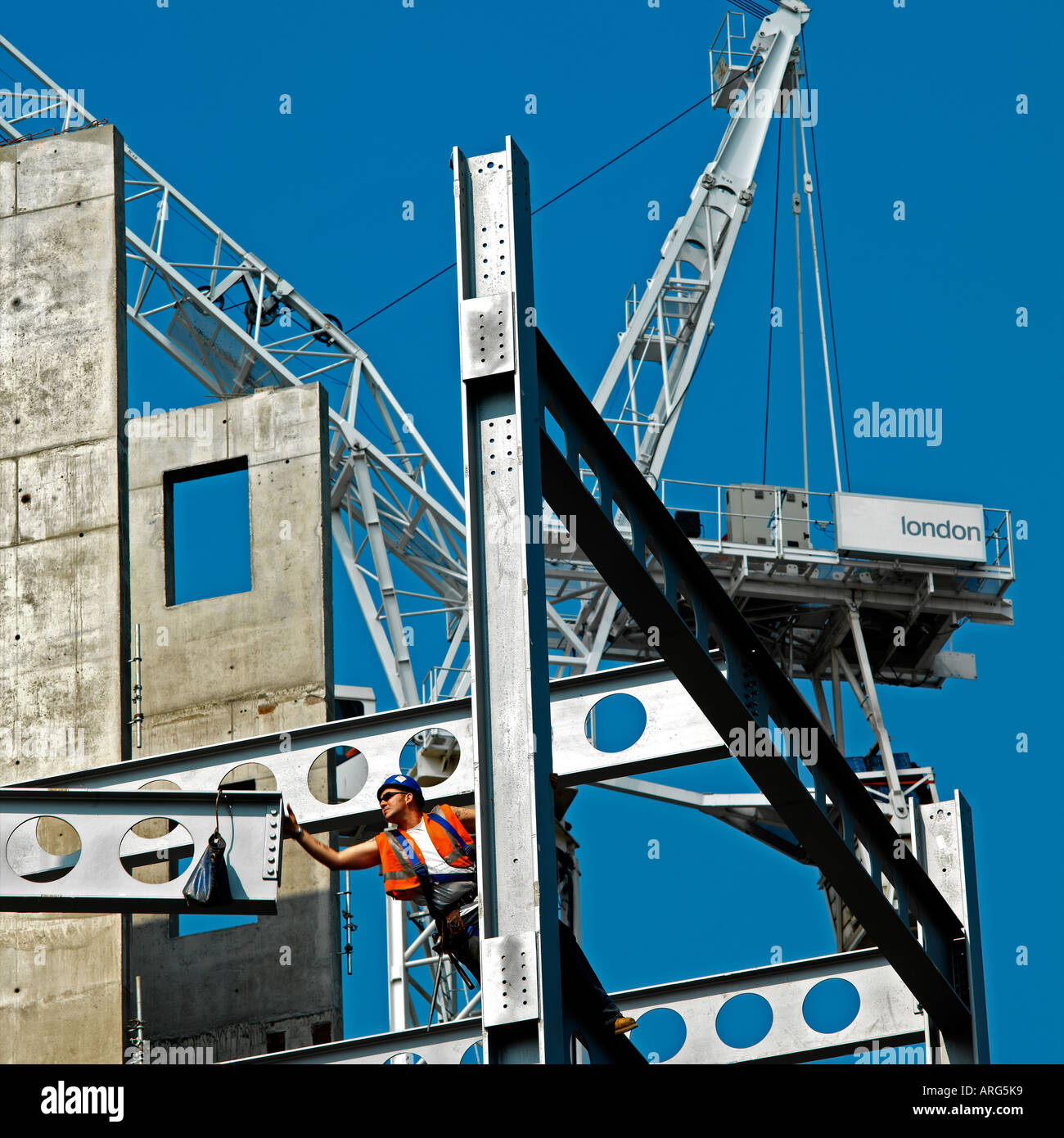 steeplejack positioning girder as part of construction work Stock Photo ...