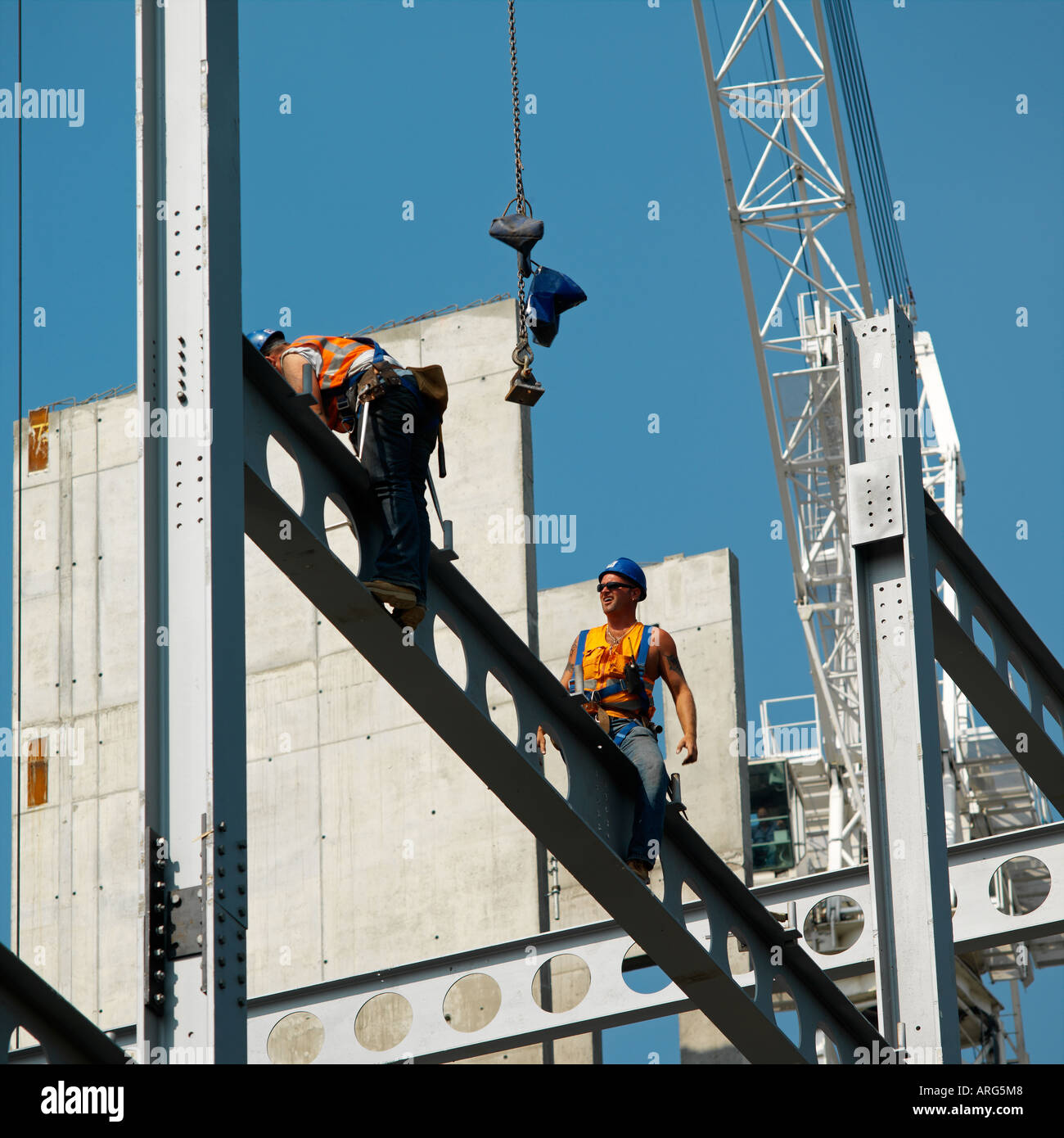 construction workers on girders with crane mechanism Stock Photo - Alamy