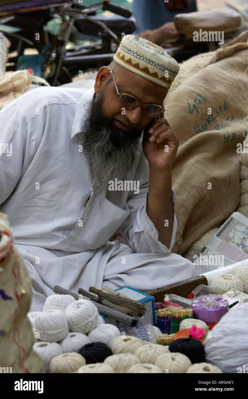Indian man in a traditional market using a mobile phone Stock Photo - Alamy