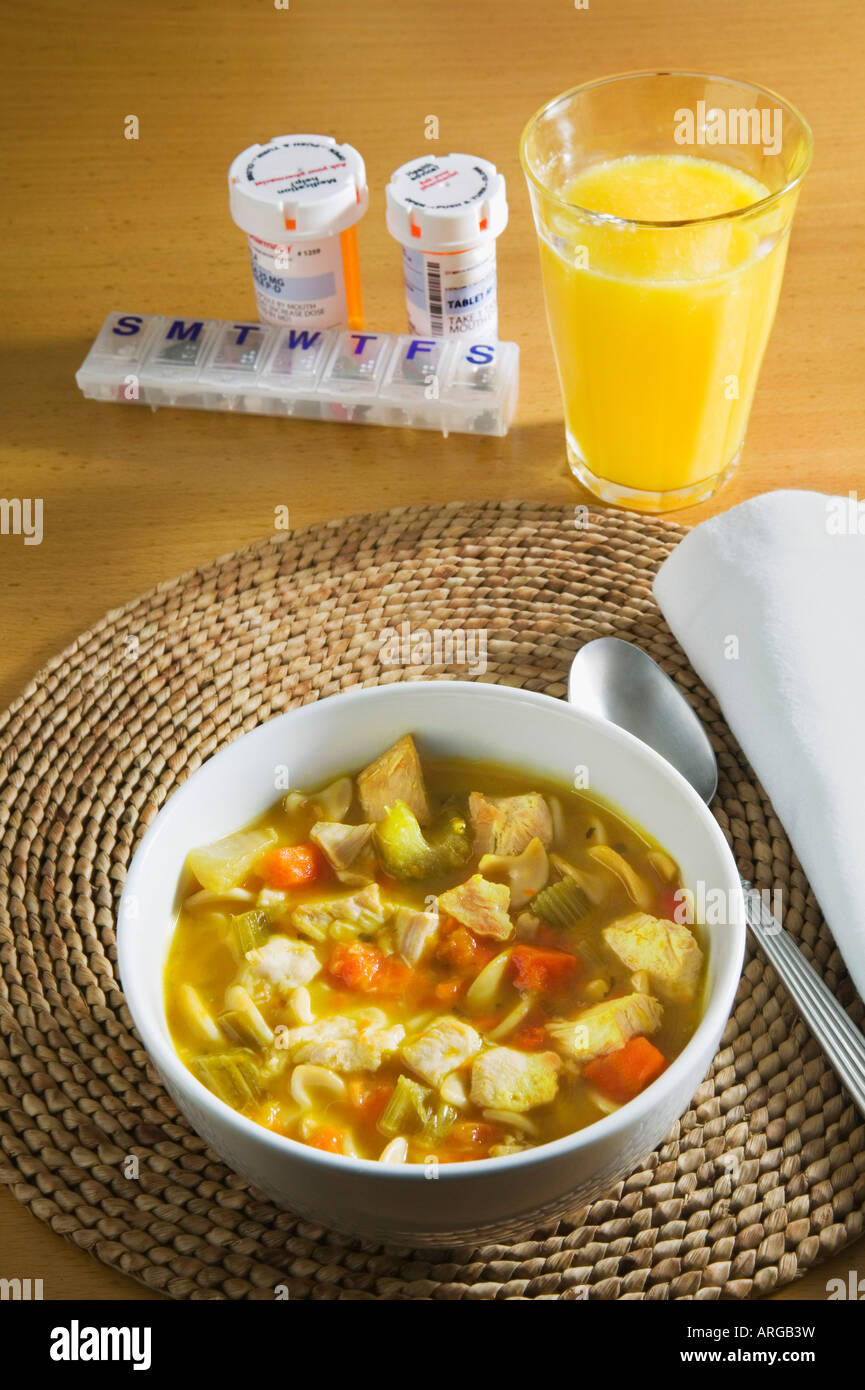 Chicken Soup with Orange Juice and Pills Stock Photo - Alamy