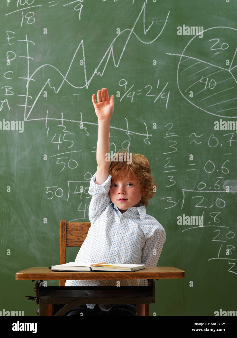 Boy Raising Hand at School Stock Photo - Alamy