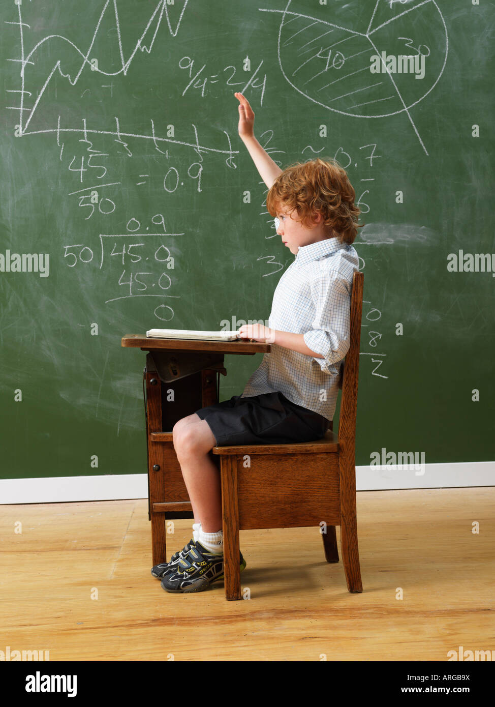 Boy Raising Hand at School Stock Photo - Alamy