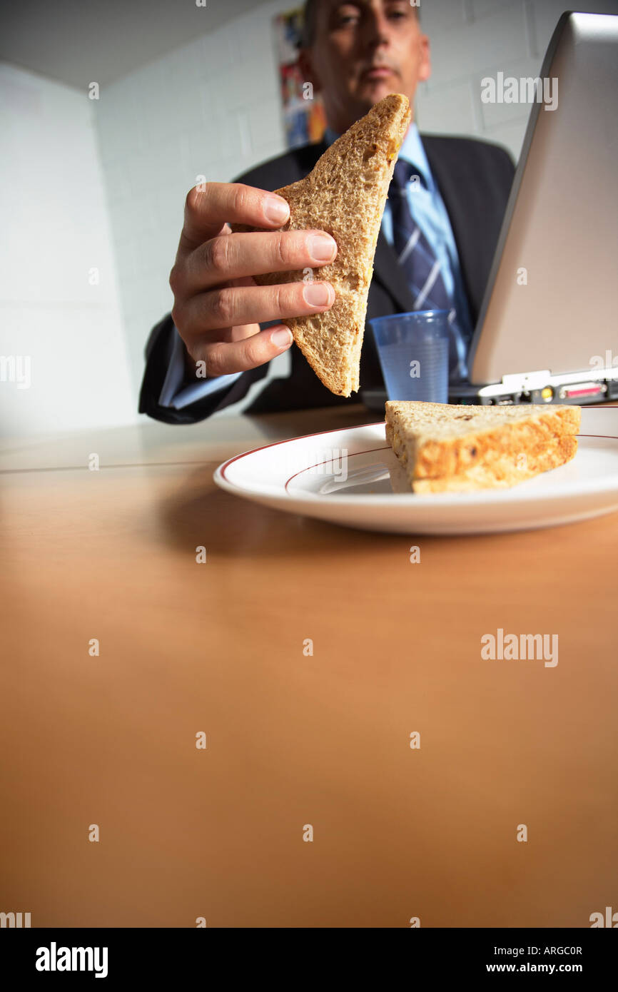 Man eating bread office hi-res stock photography and images - Alamy