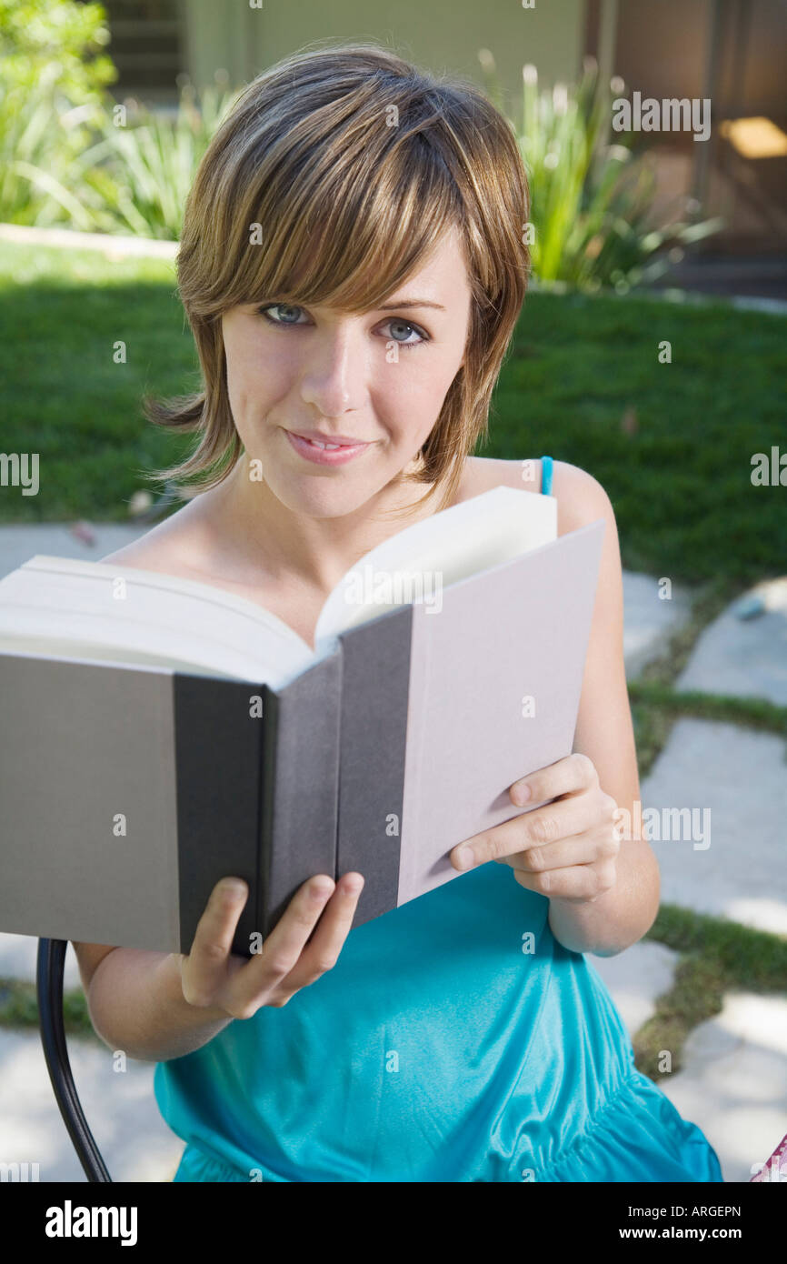 Woman Reading in Backyard Stock Photo - Alamy