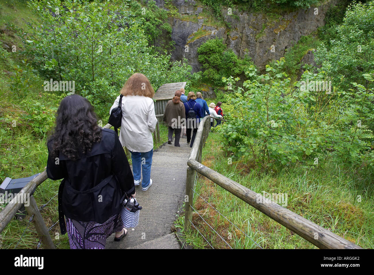 Tourists going down the long steep path to the entrance of the Marble ...