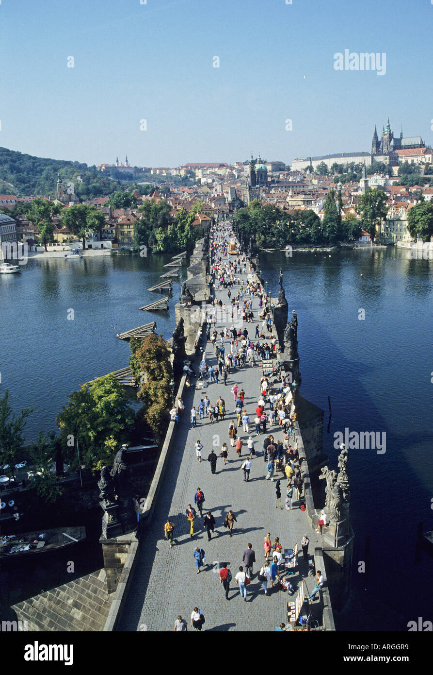 Viewed from above people passing portrait artists and street vendors on ...