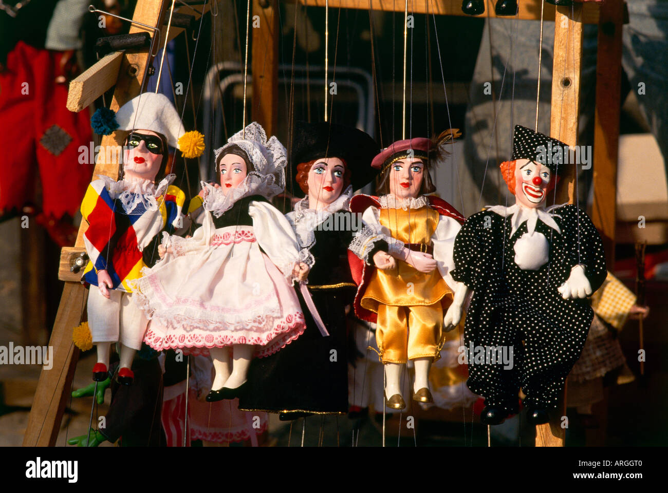 A collection of string puppets in colourful costumes displayed for sale ...