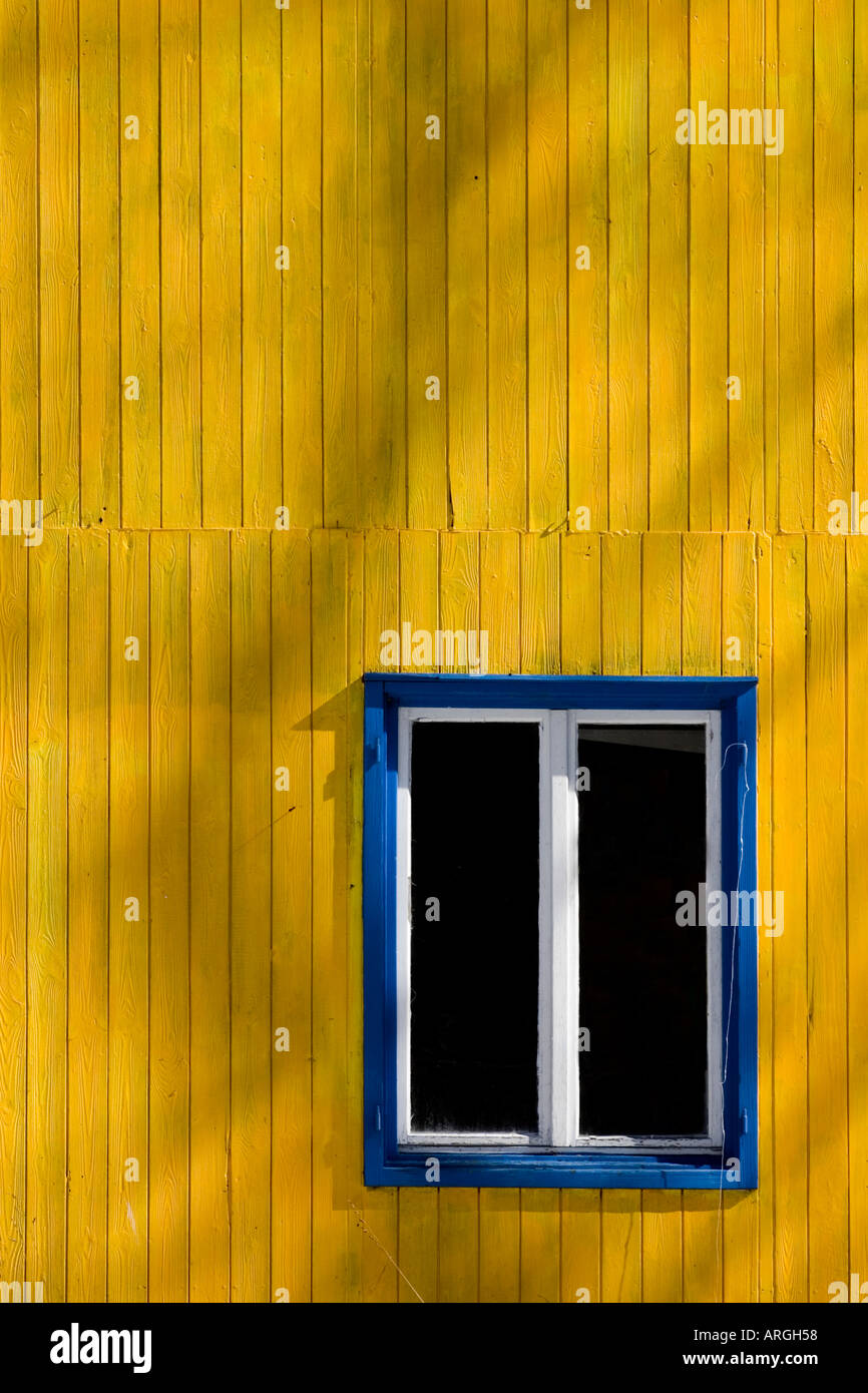 blue window in a yellow wall Stock Photo - Alamy