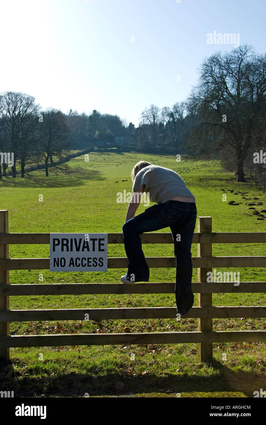 Girl climbing over fence hi-res stock photography and images - Alamy