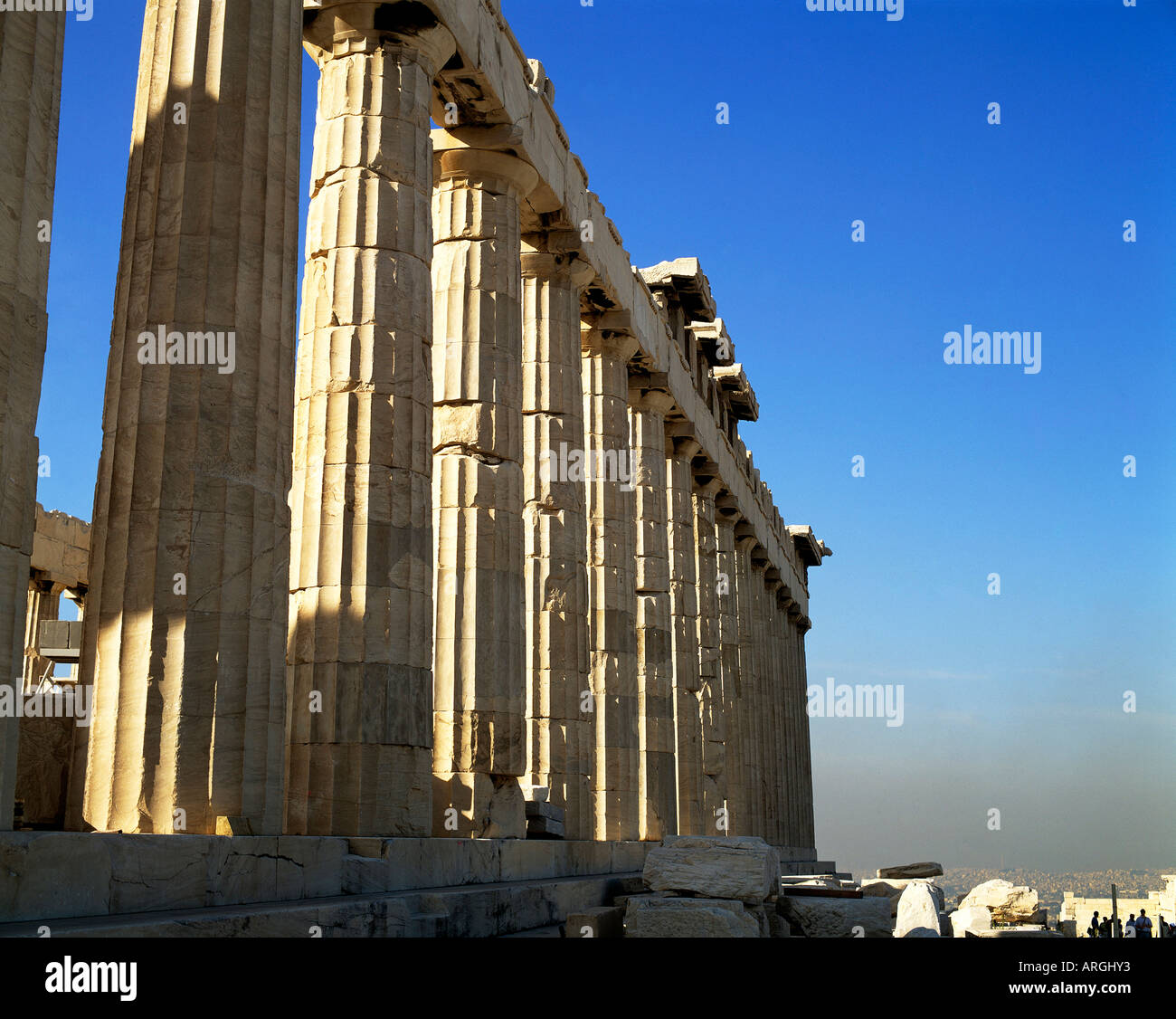 Viewed at an angle sunshine warming the columns of the Doric temple of ...