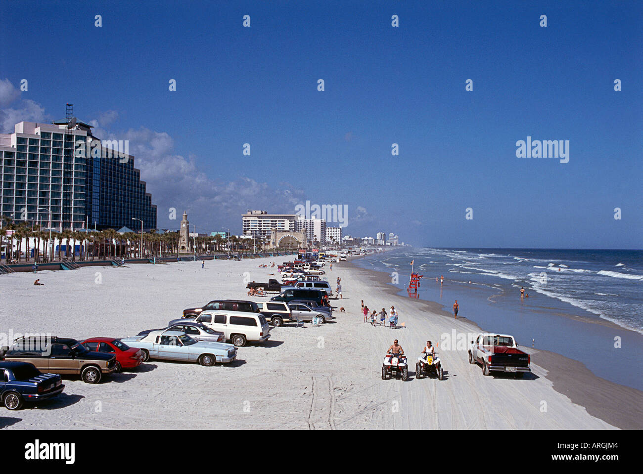 Cars trucks and buggies park on the hard packed sand of Daytona Beach ...