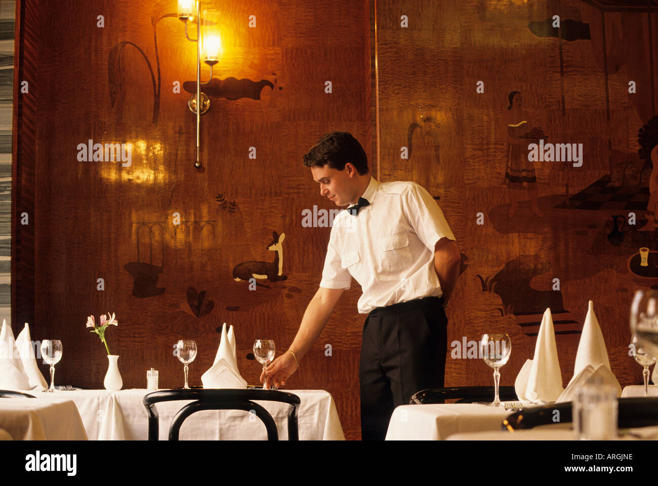 A waiter checks the set tables in the walnut panelled Art Deco Parnas ...