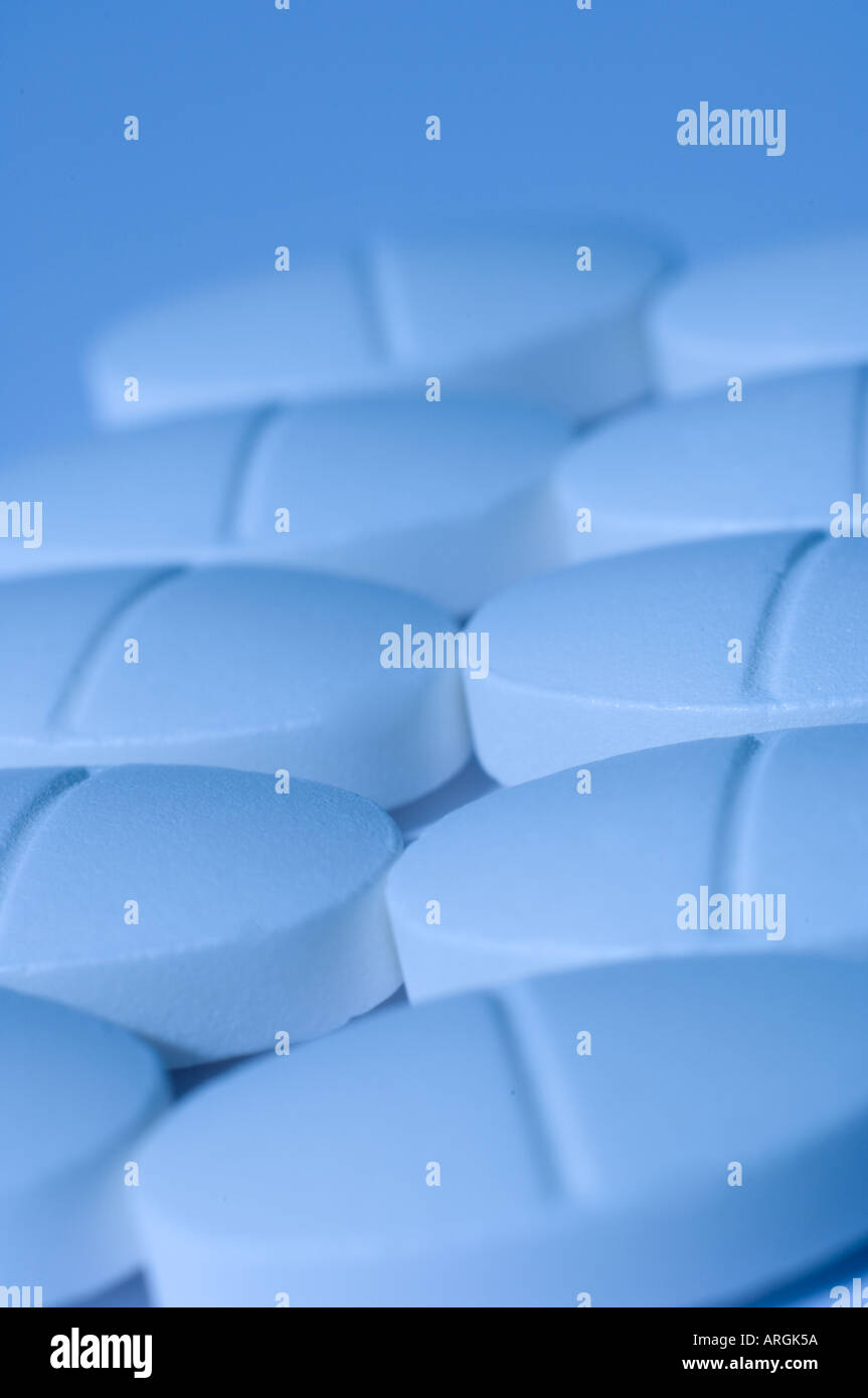 Small white medicinal tablets with fresh blue toning Stock Photo - Alamy