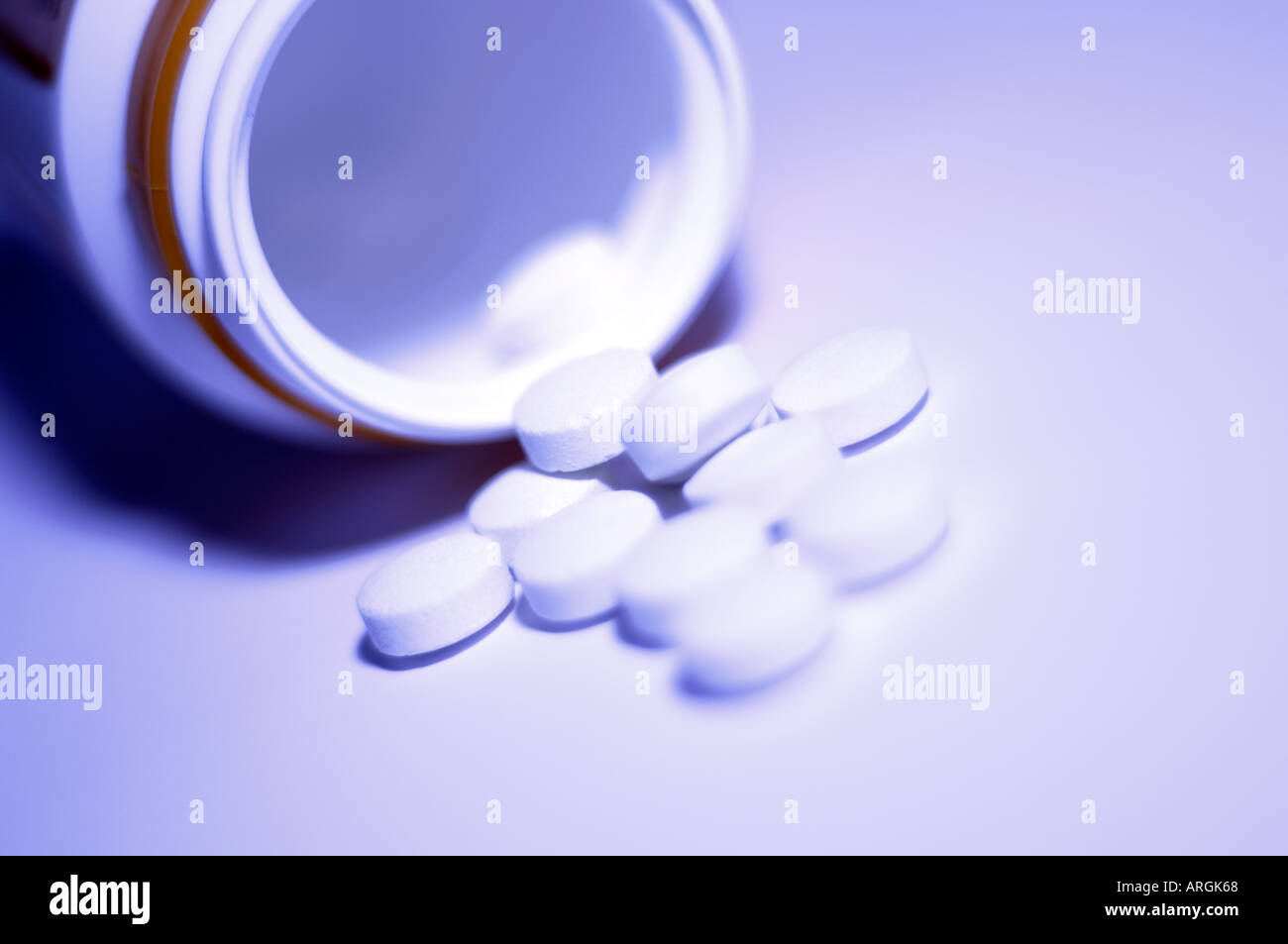 Small white medicinal tablets with fresh violet toning Stock Photo - Alamy