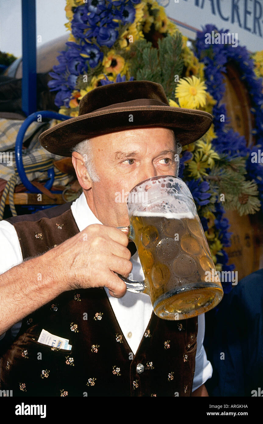 The traditionally dressed driver of a dray enjoying a stein of beer at ...