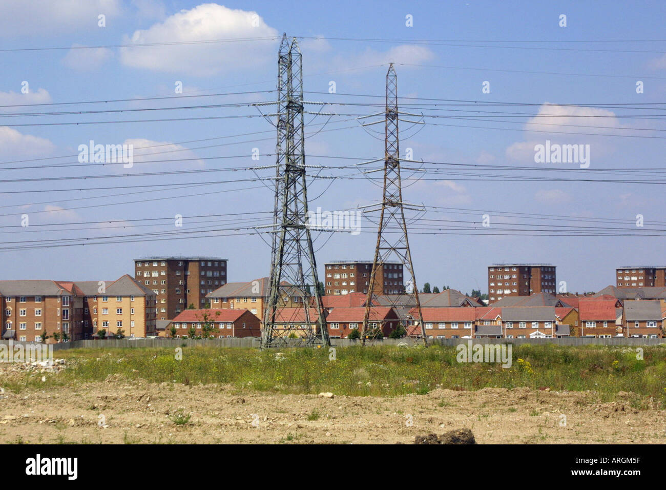 Power lines passing through new build town Stock Photo - Alamy