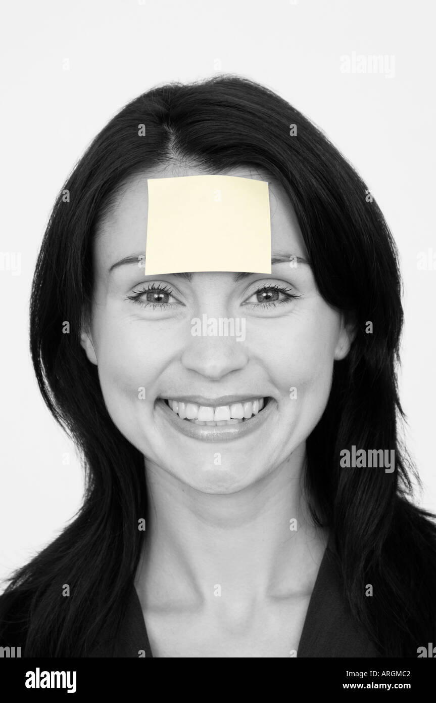 smiling business woman with a blank post it note on her head Stock ...