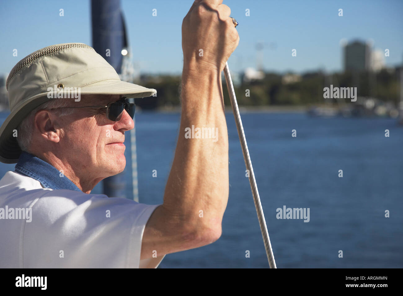 Man on Sailboat Stock Photo - Alamy