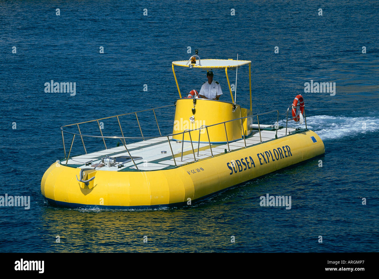 A bright yellow boat with the words Subsea Explorer glides across the ...