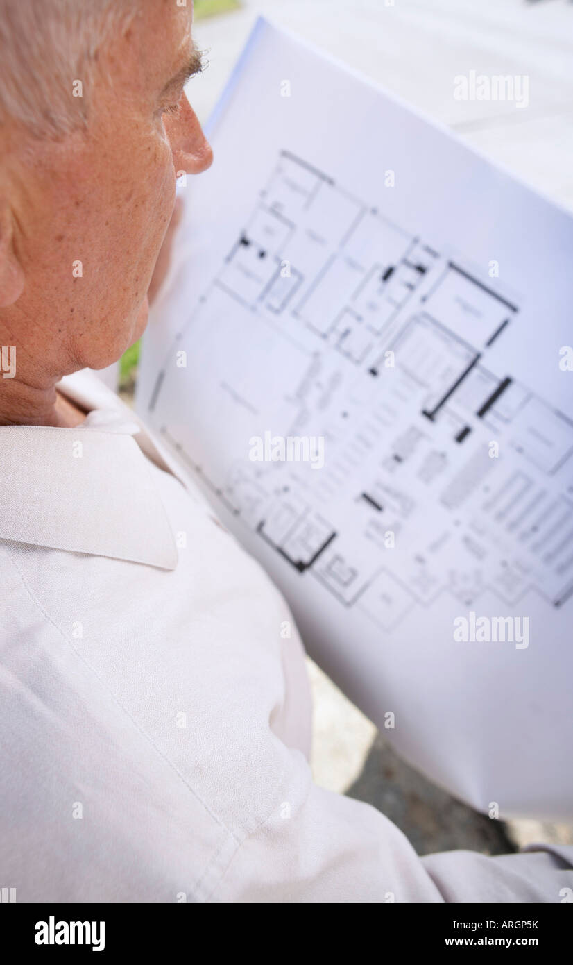 Man Examining Blueprint Stock Photo - Alamy