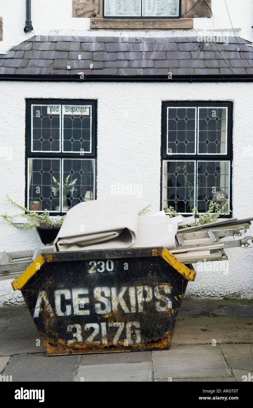 Building skip in front of house Stock Photo - Alamy