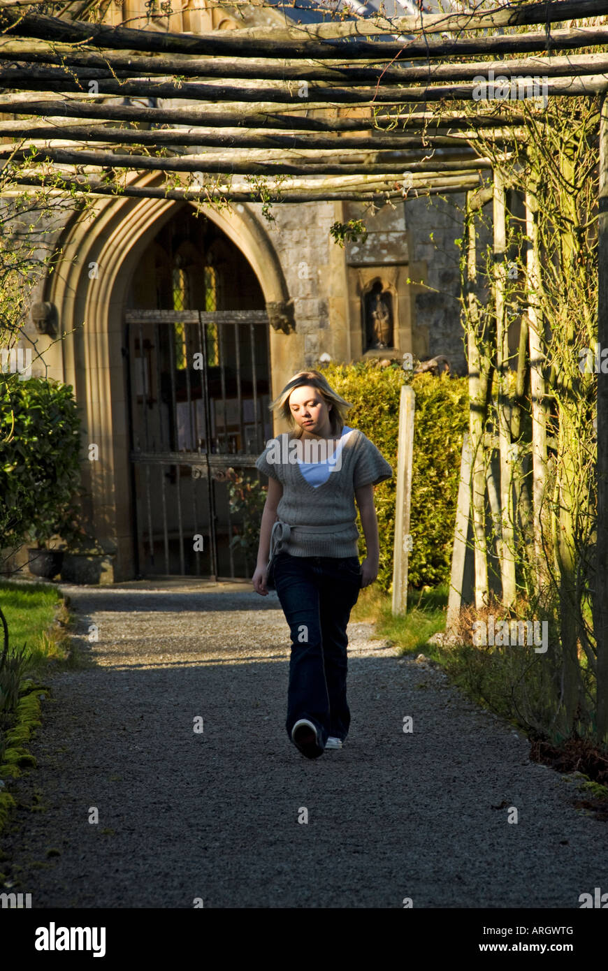 teenage girl walking away from church Stock Photo - Alamy