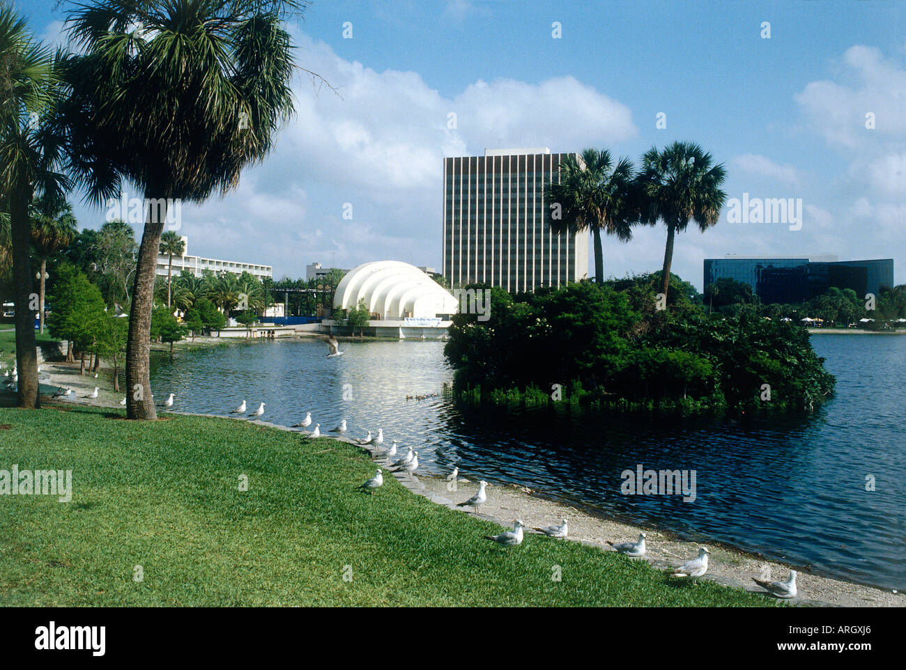 A large hotel towers above the white semicircular shaped Disney ...