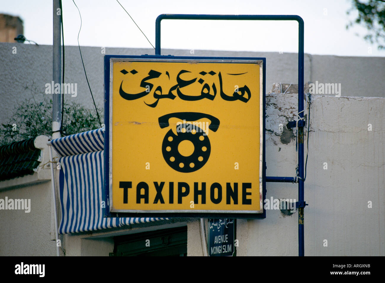 Detail of a sign indicating in Arabic and English a taxiphone possibly ...