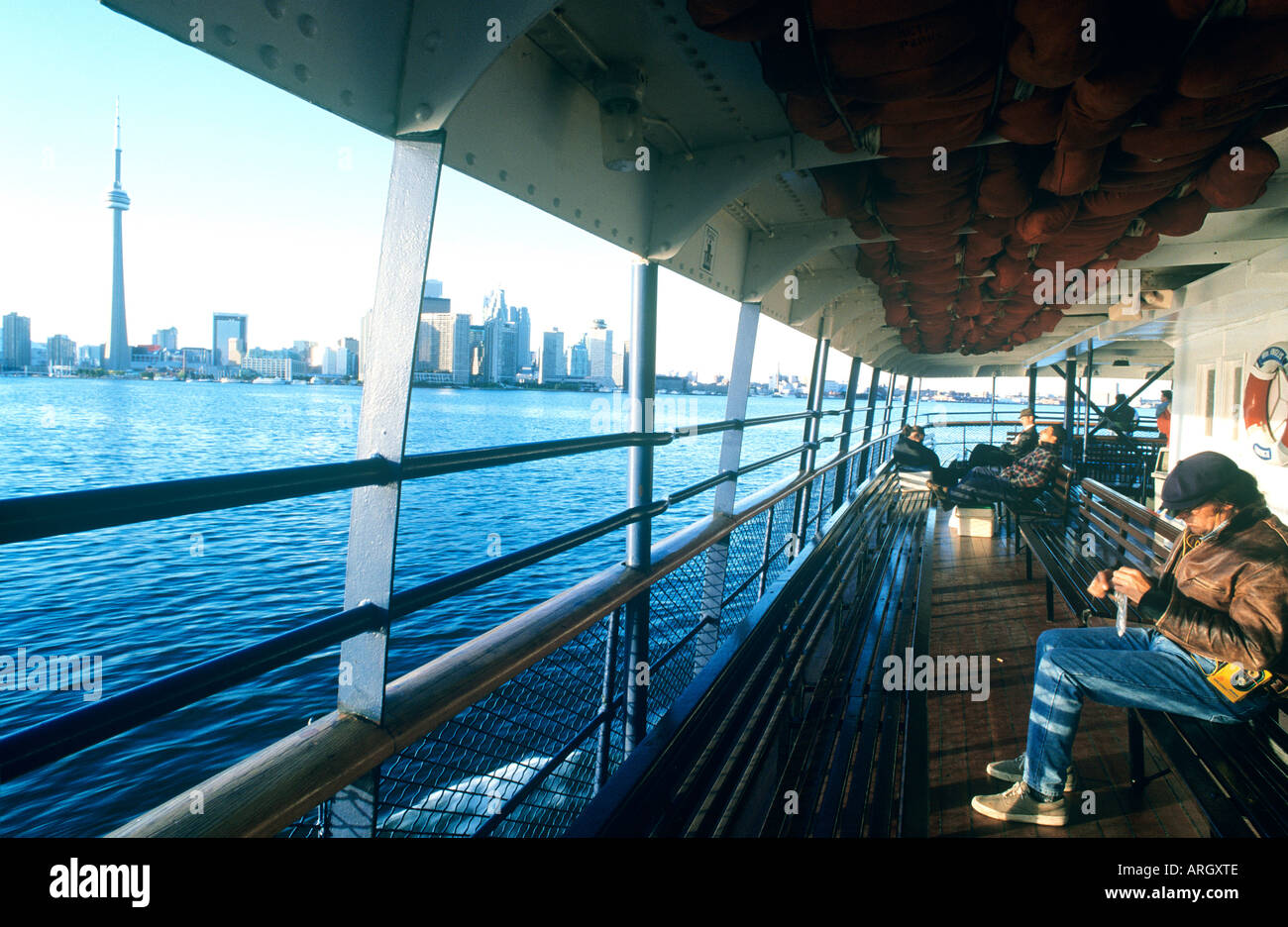 Passengers sitting on the lower deck of one of the ferries which ply ...
