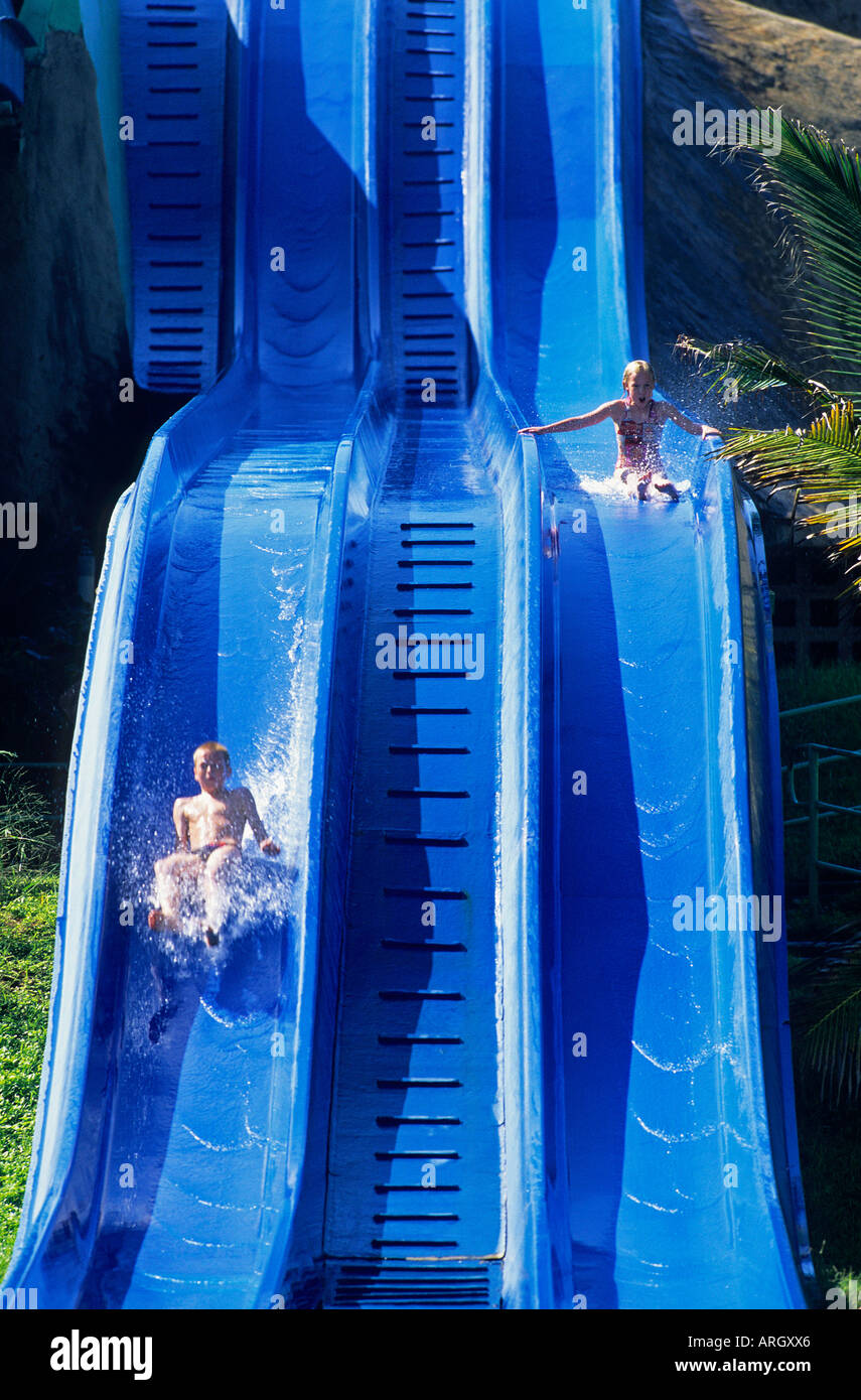 People plunging down a huge chute in Waterworld an extensive complex of ...