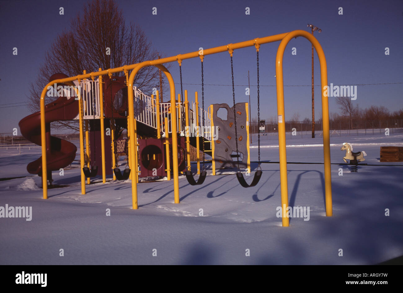 Swings and slides in a park Stock Photo - Alamy