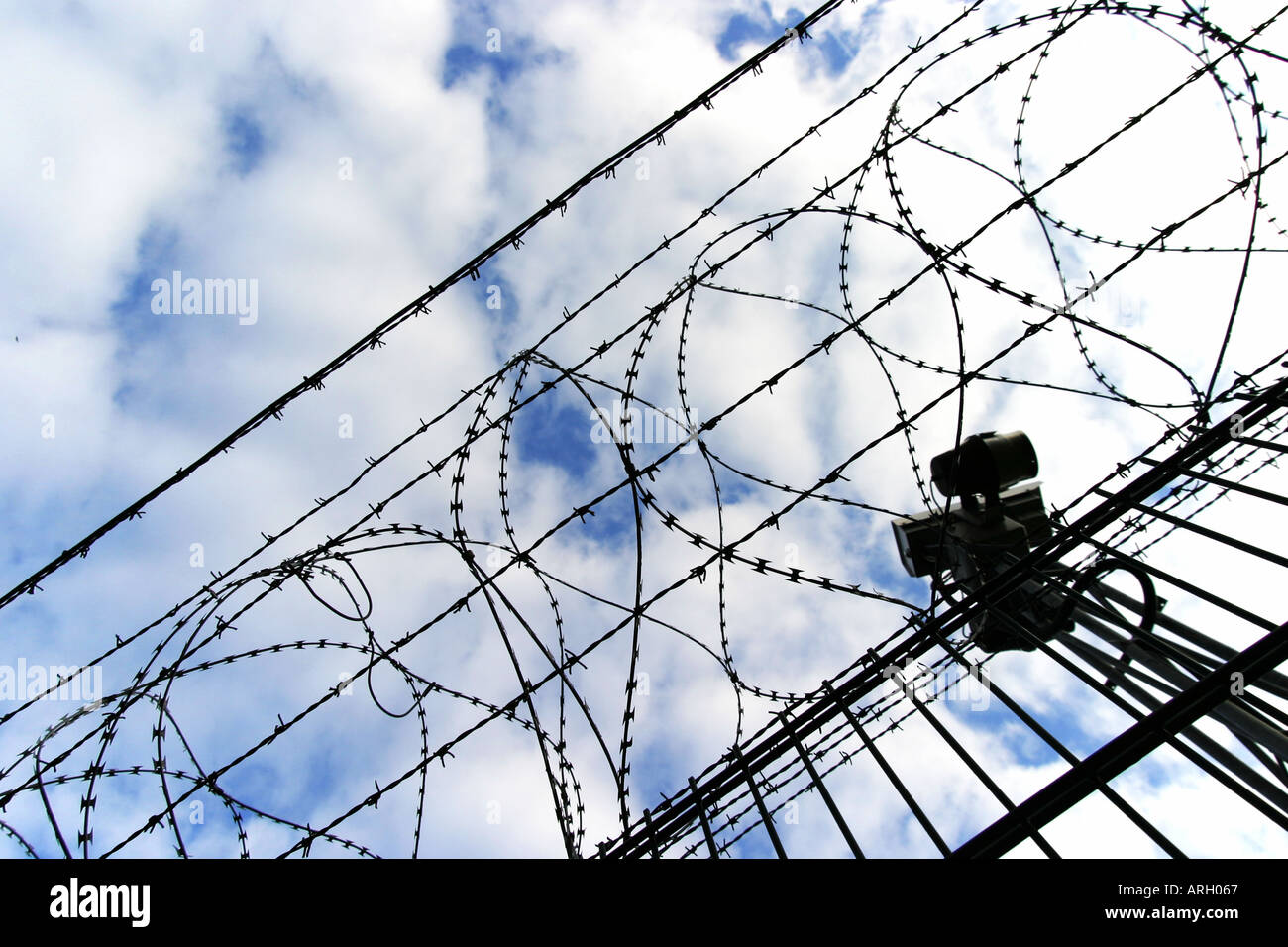 Security fence wire razor wire surveillance Stock Photo - Alamy